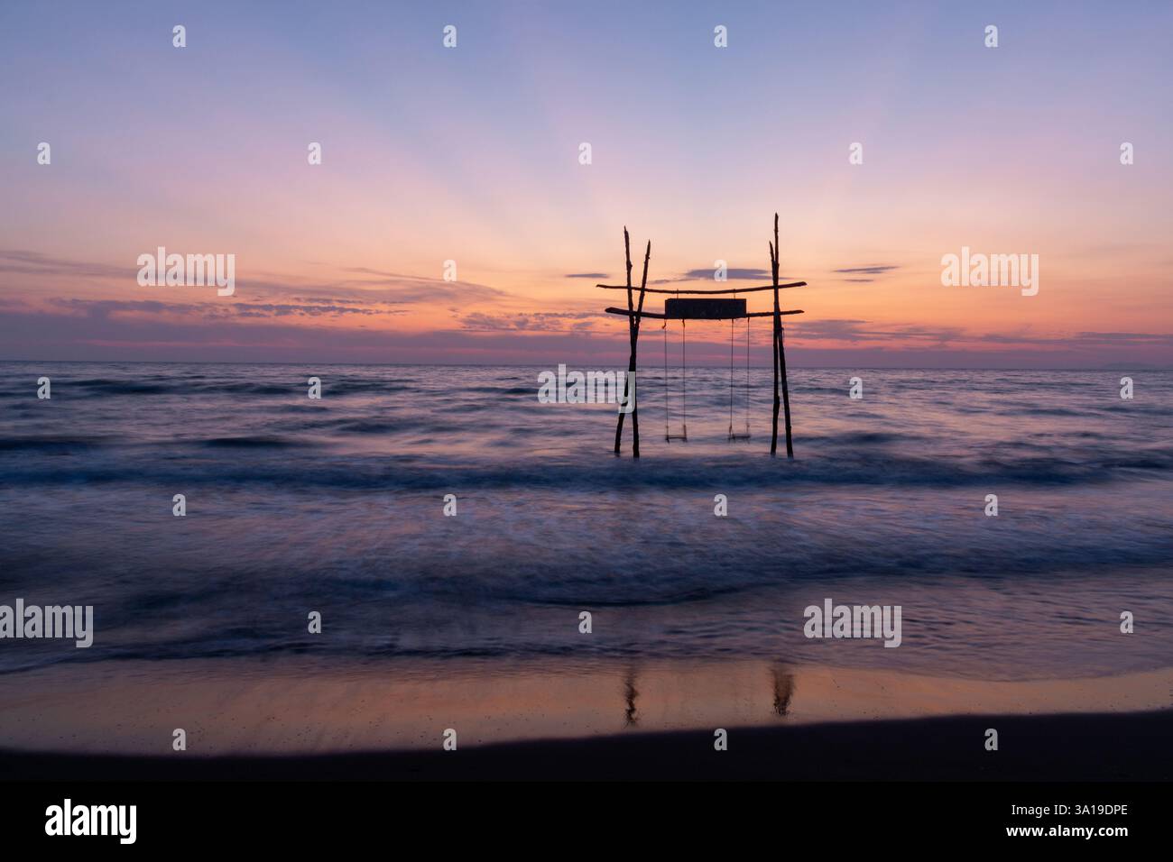 Swing in the sea at sunset in Tale, Albania Stock Photo - Alamy