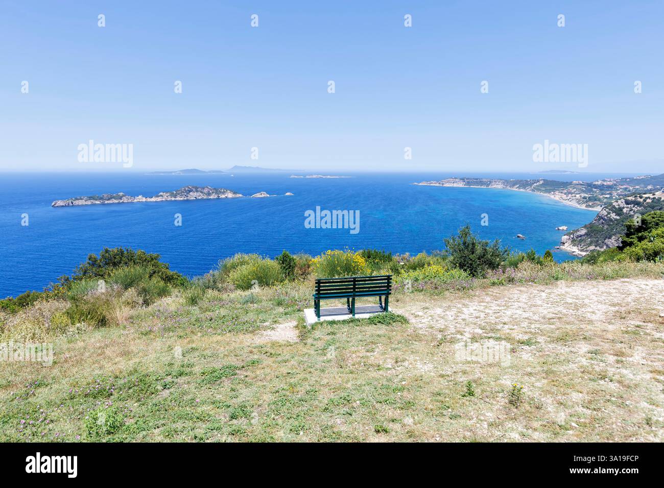 Corfu, Greece, View with bench and view of Arillas Bay with turquoise ...