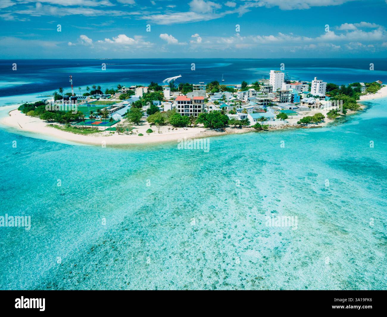 Gulhi island in Kaafu atoll. Local island with blue ocean in Maldives ...