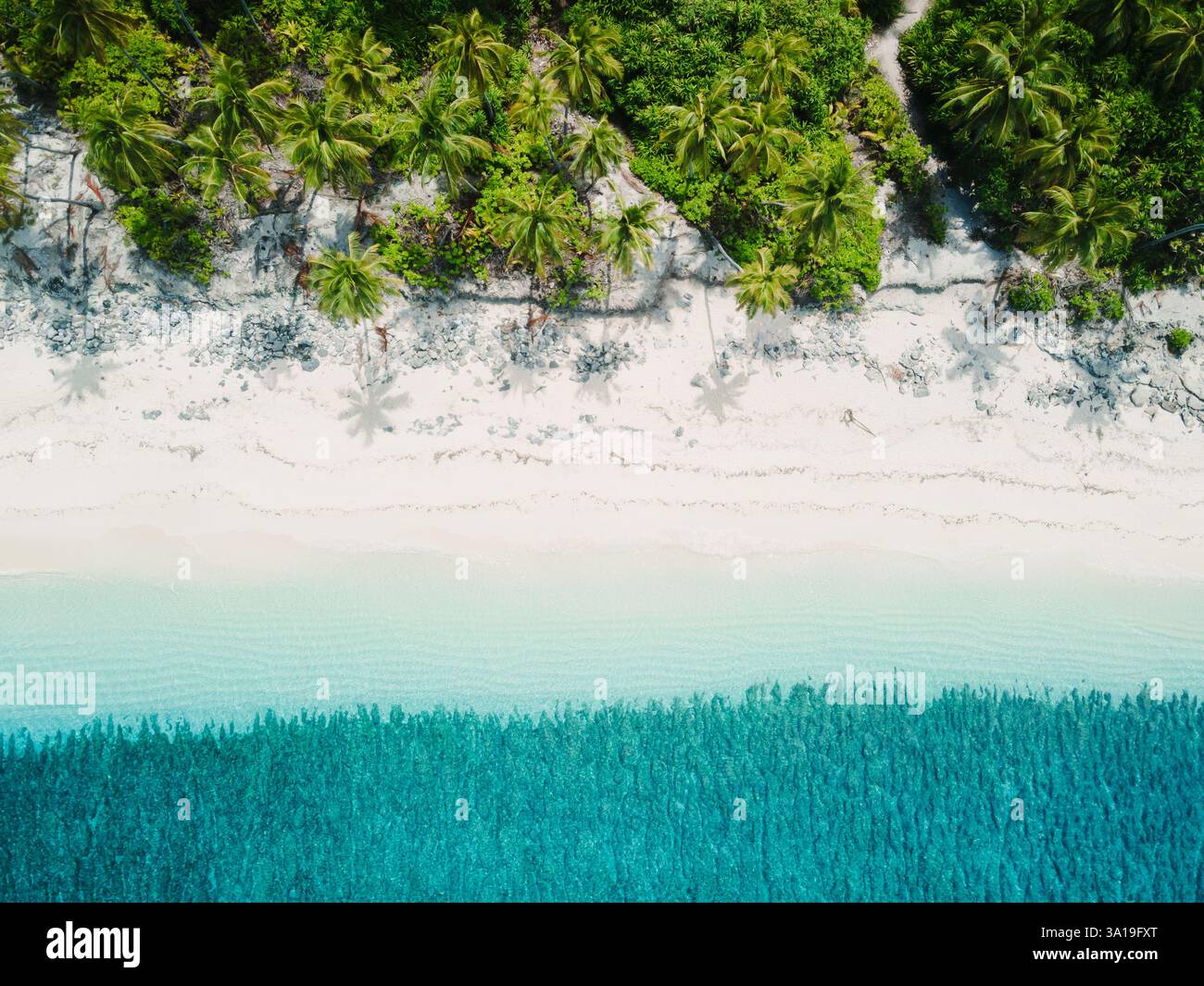 Drone view of shoreline in Maldives. Blue crystal clear water and ...