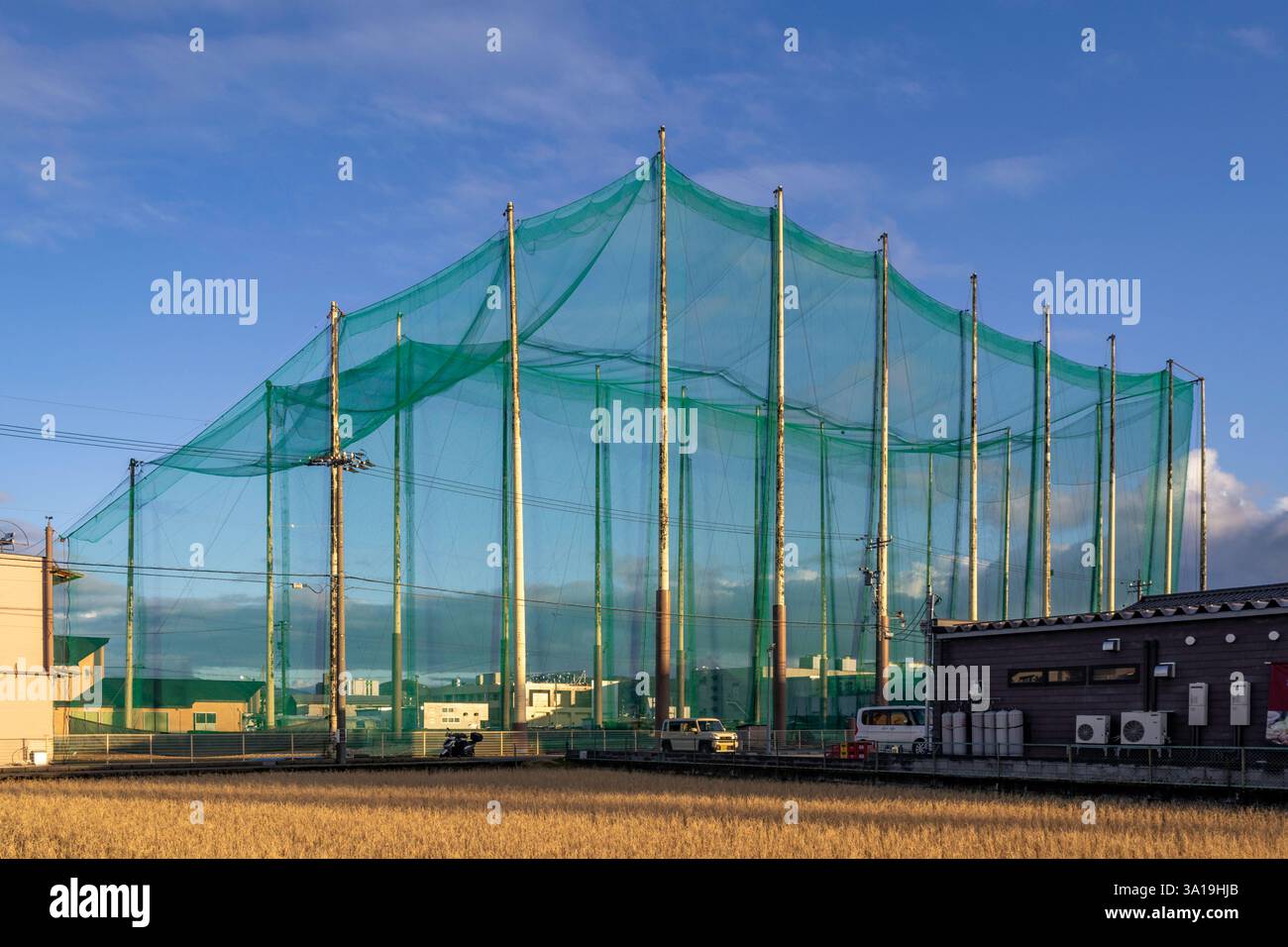 Outdoor golf driving practice range with netting, Hanazato, Nonoichi ...