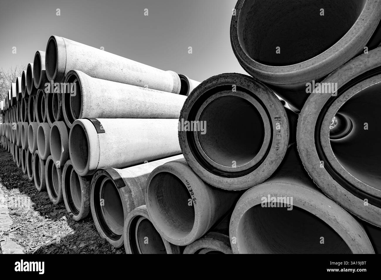 Stacked concrete pipes in black and white hi-res stock photography and ...