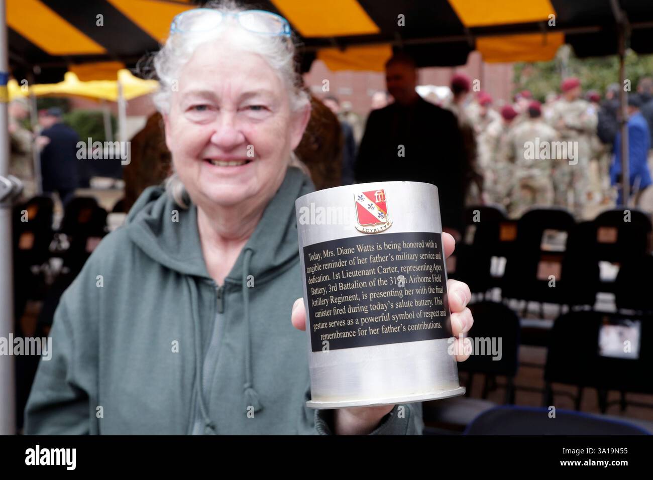 Diane Watts, daughter of PFC Roland Bragg, holds a shell canister that ...