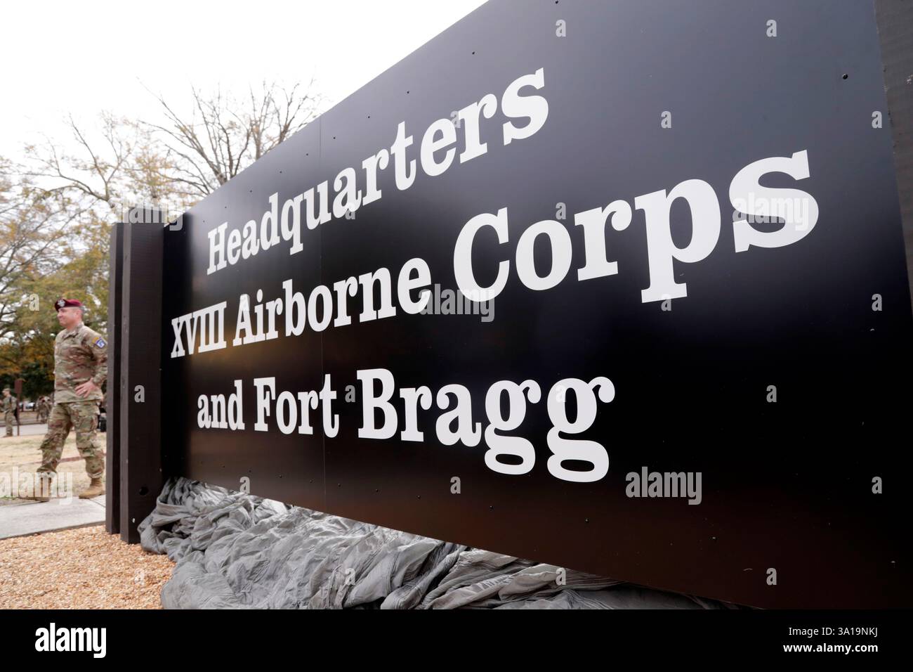 A soldier stands beside the sign that was unveiled when Fort Liberty ...