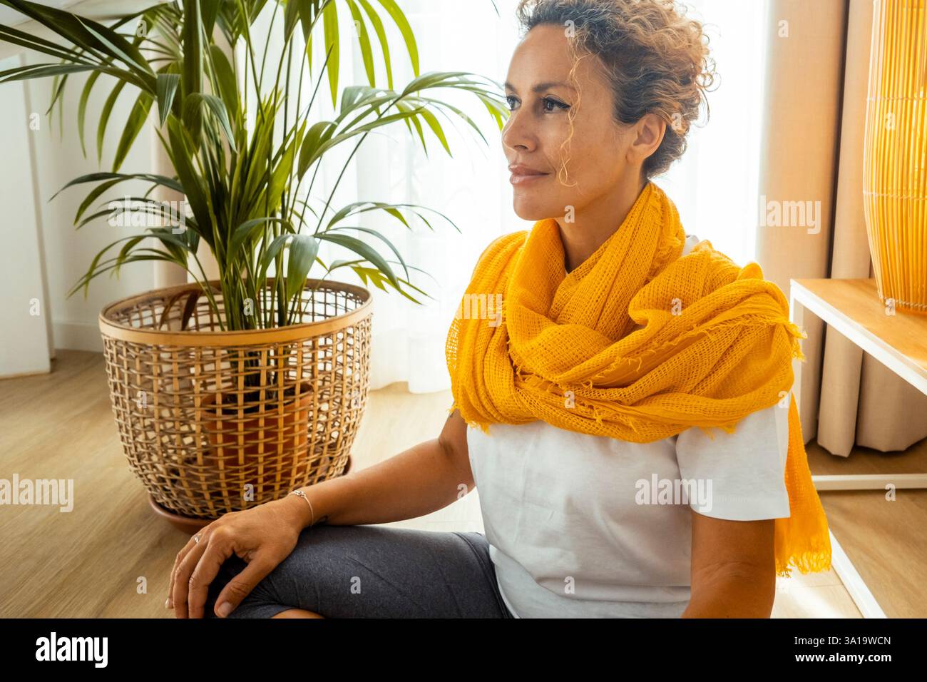 Portrait of authentic serene lady at home sitting on the floor in ...