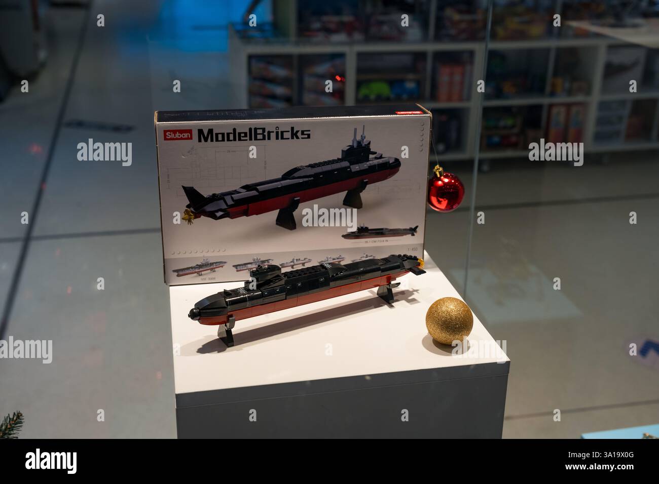 Creative display of a model submarine kit with festive decorations at a ...
