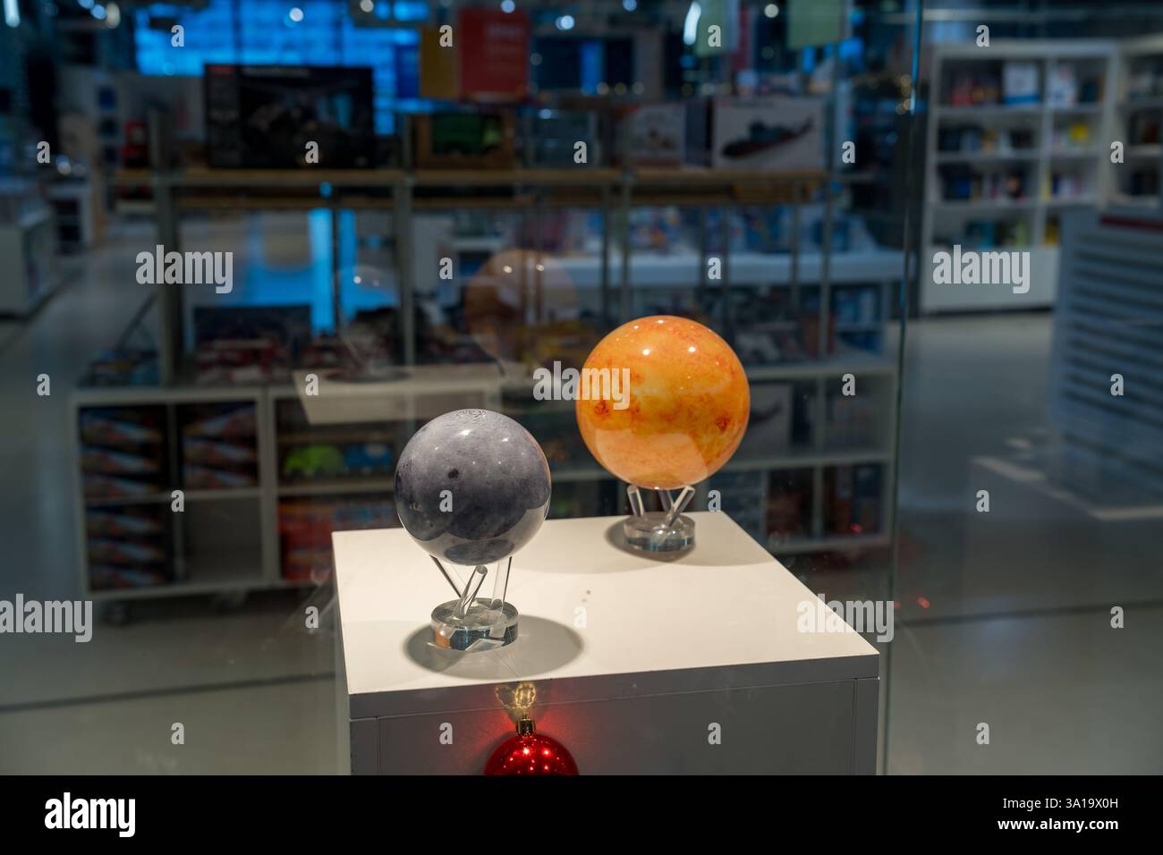 Miniature celestial sculptures illuminate a store display, captivating ...