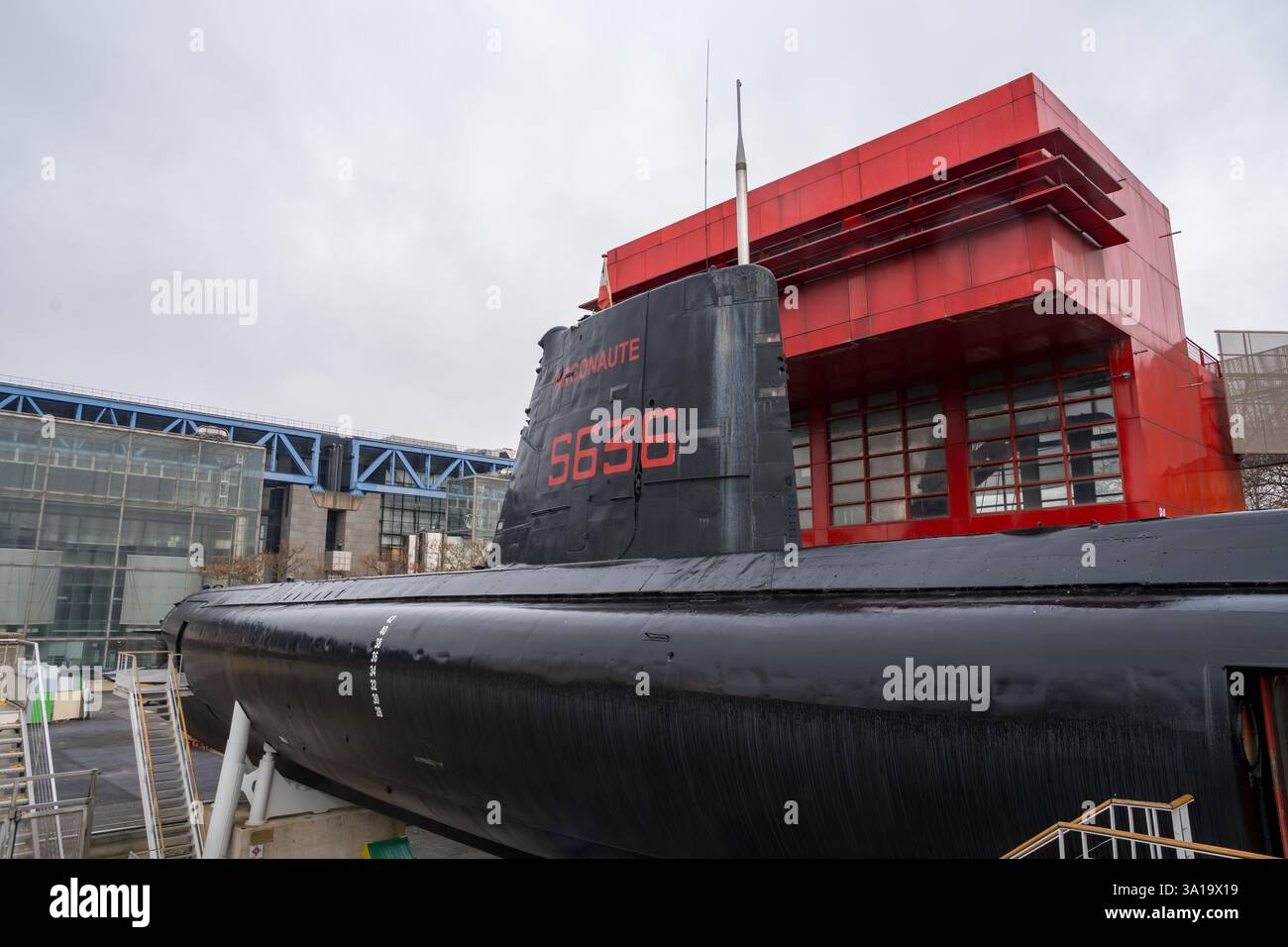 Submarine rests at dock, showcasing its robust design near modern ...