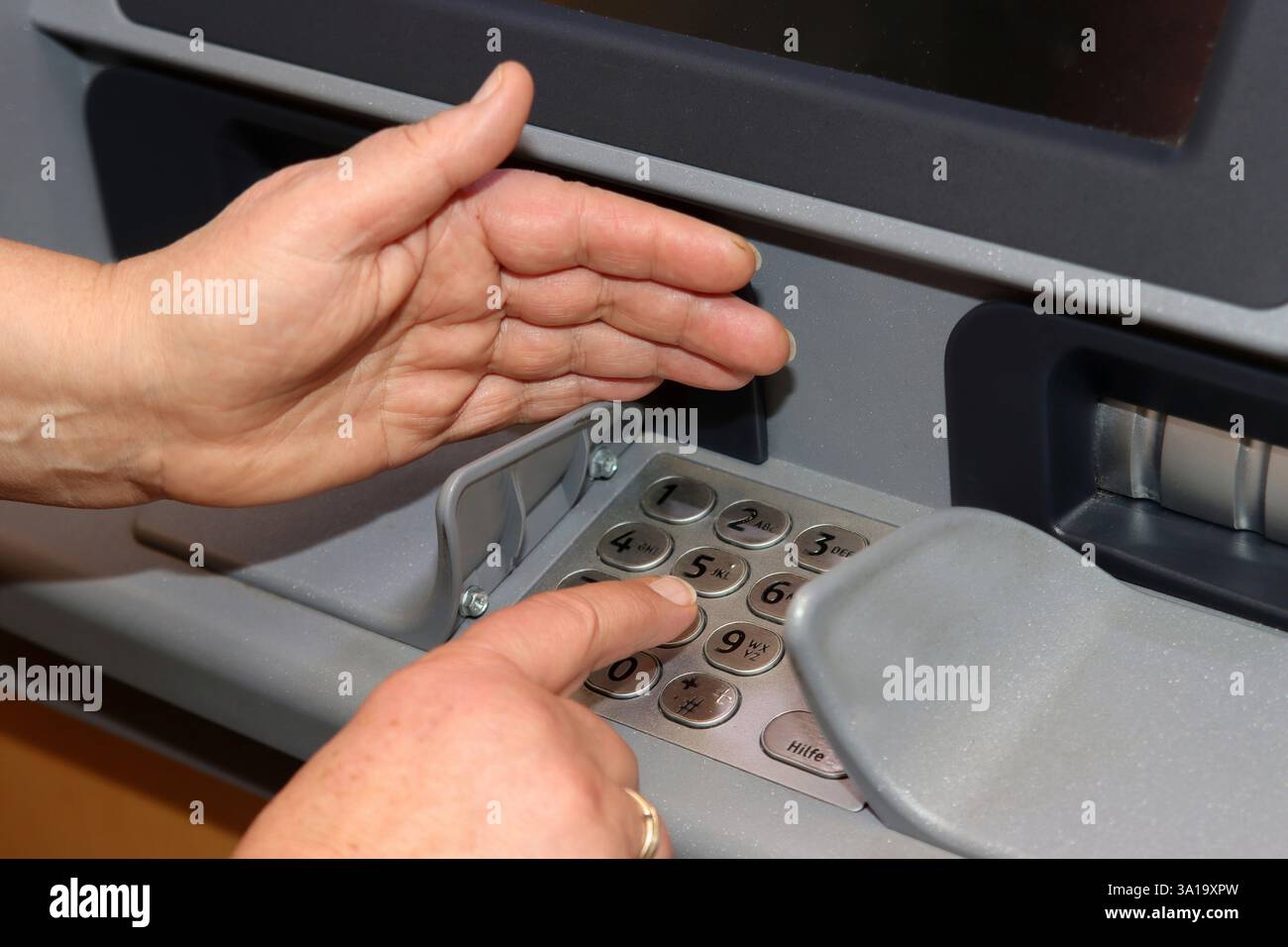 Woman enters PIN number at ATM Stock Photo - Alamy