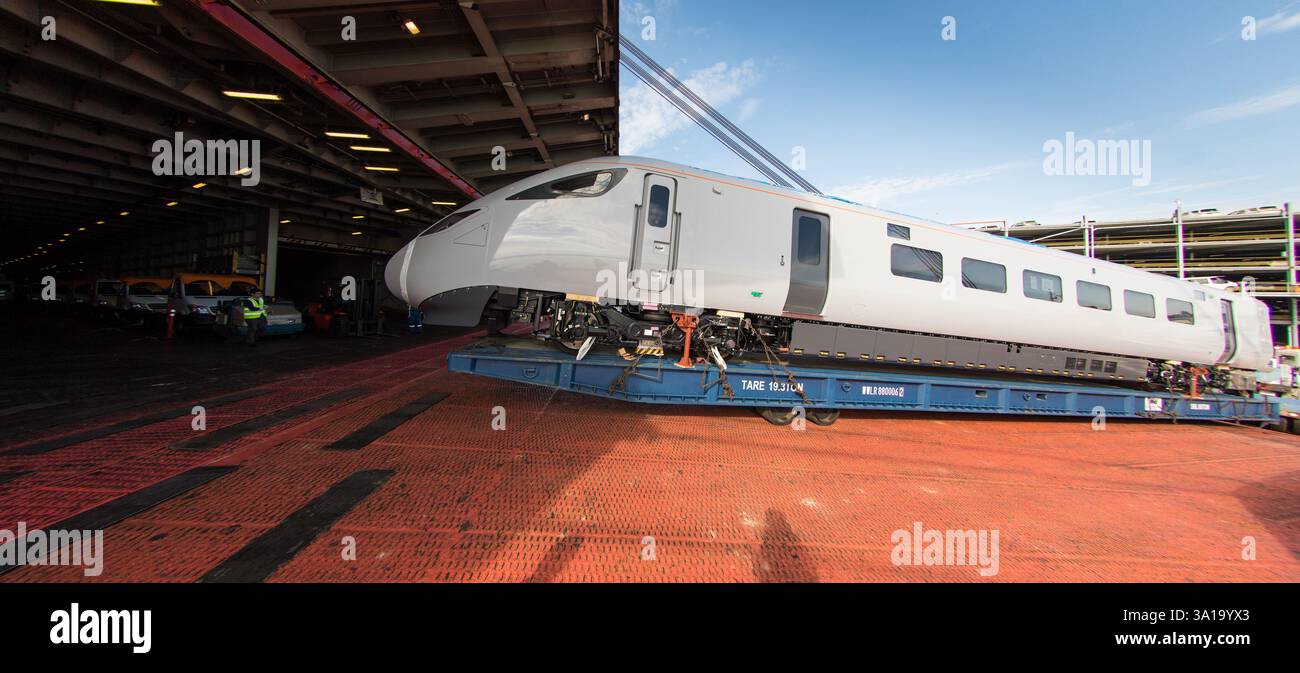 New train being transported on a flatbed, at a port facility in Southampton UK. Likely being ...
