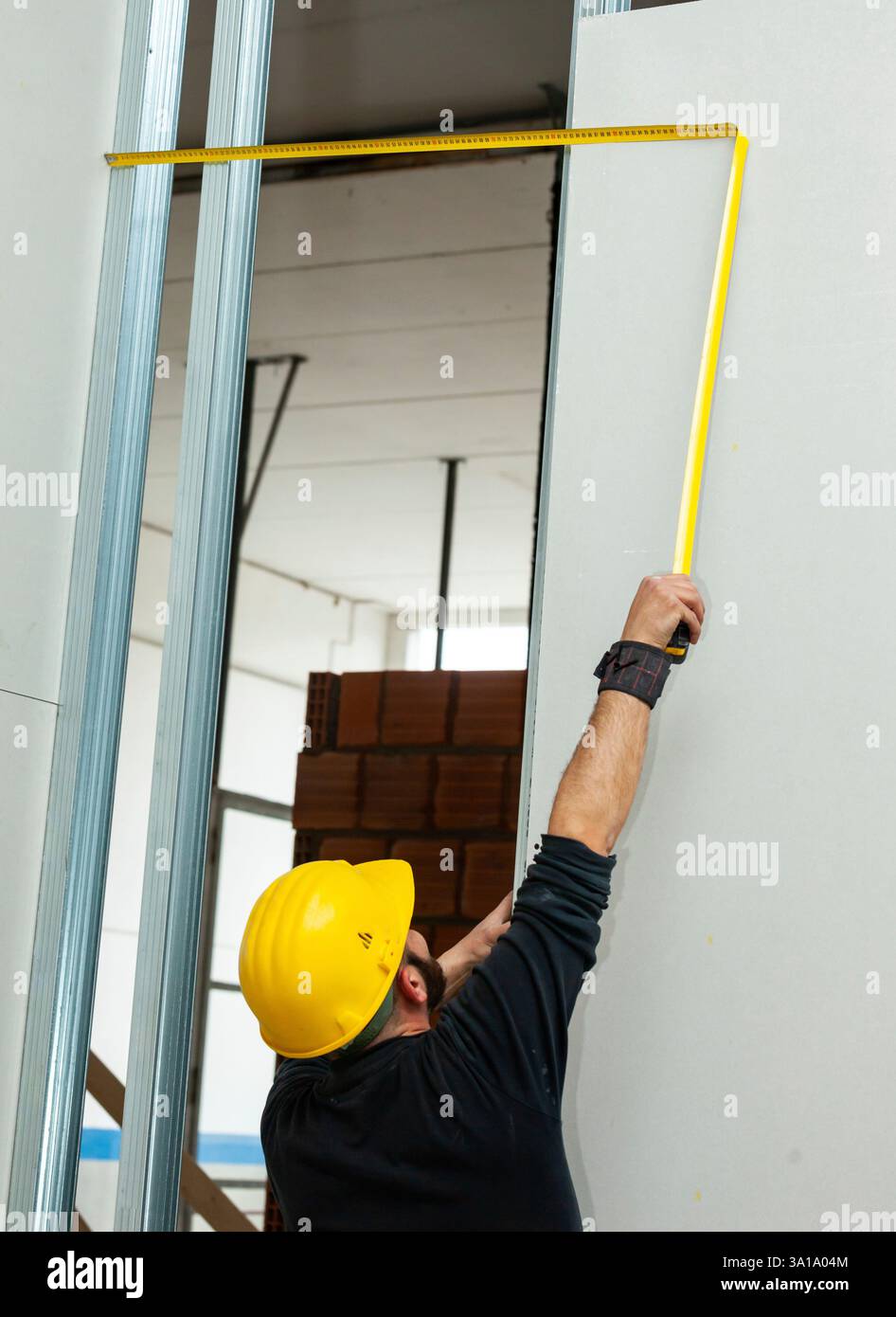 Worker at work in the construction of a plasterboard wall Stock Photo ...