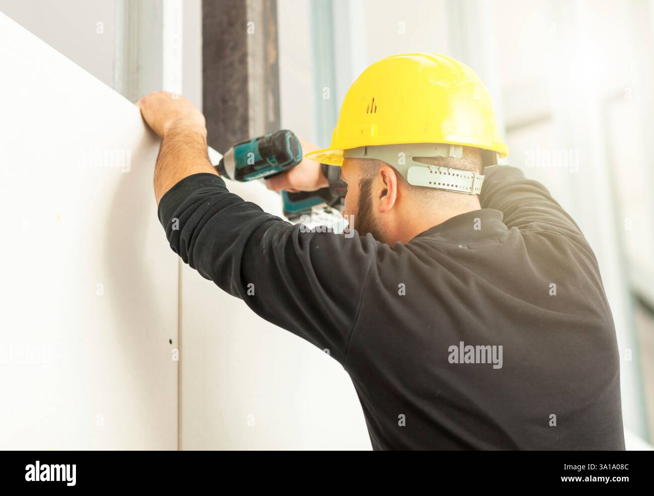 Worker at work in the construction of a plasterboard wall Stock Photo - Alamy