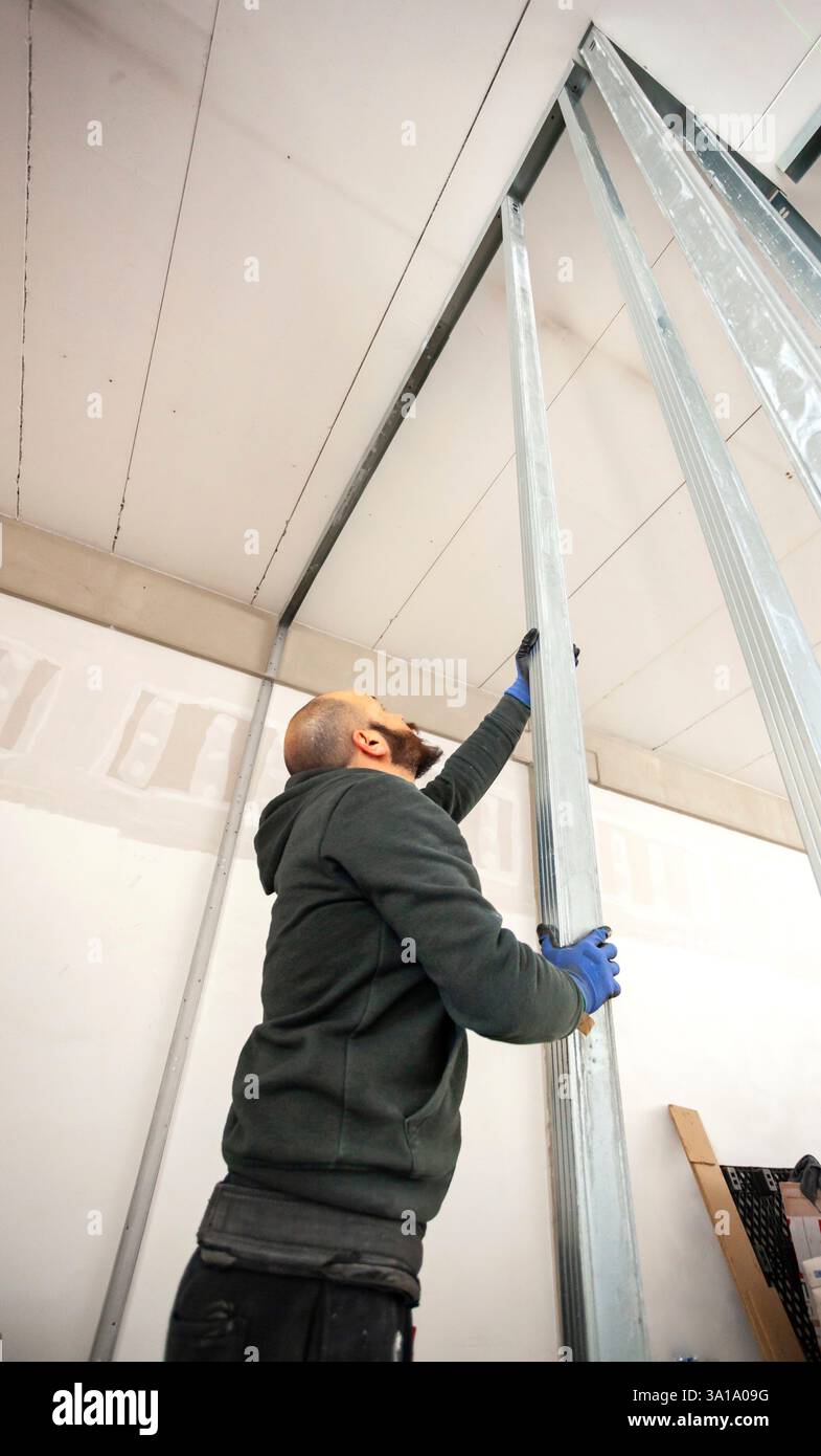 Worker at work in the construction of a plasterboard wall Stock Photo ...
