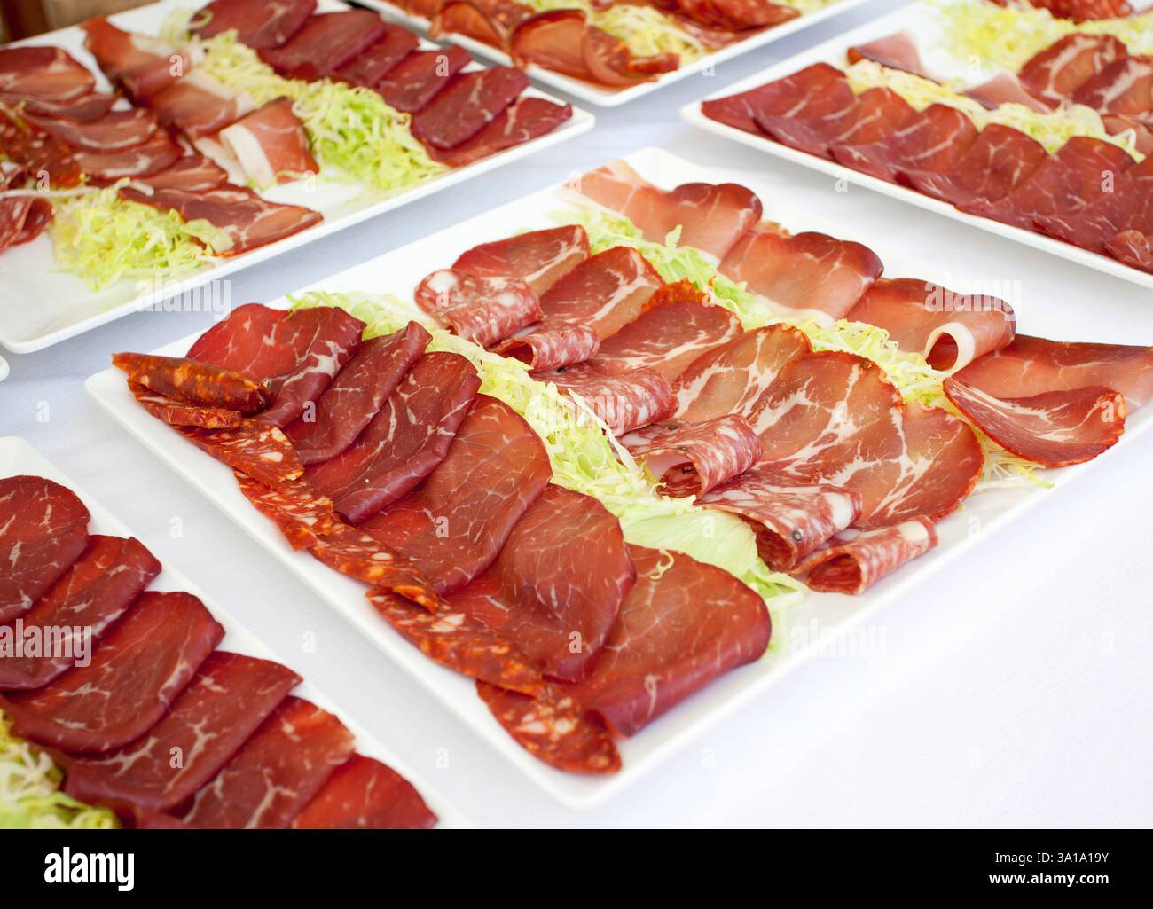 Mixed appetizers of pork meat on buffet table Stock Photo - Alamy