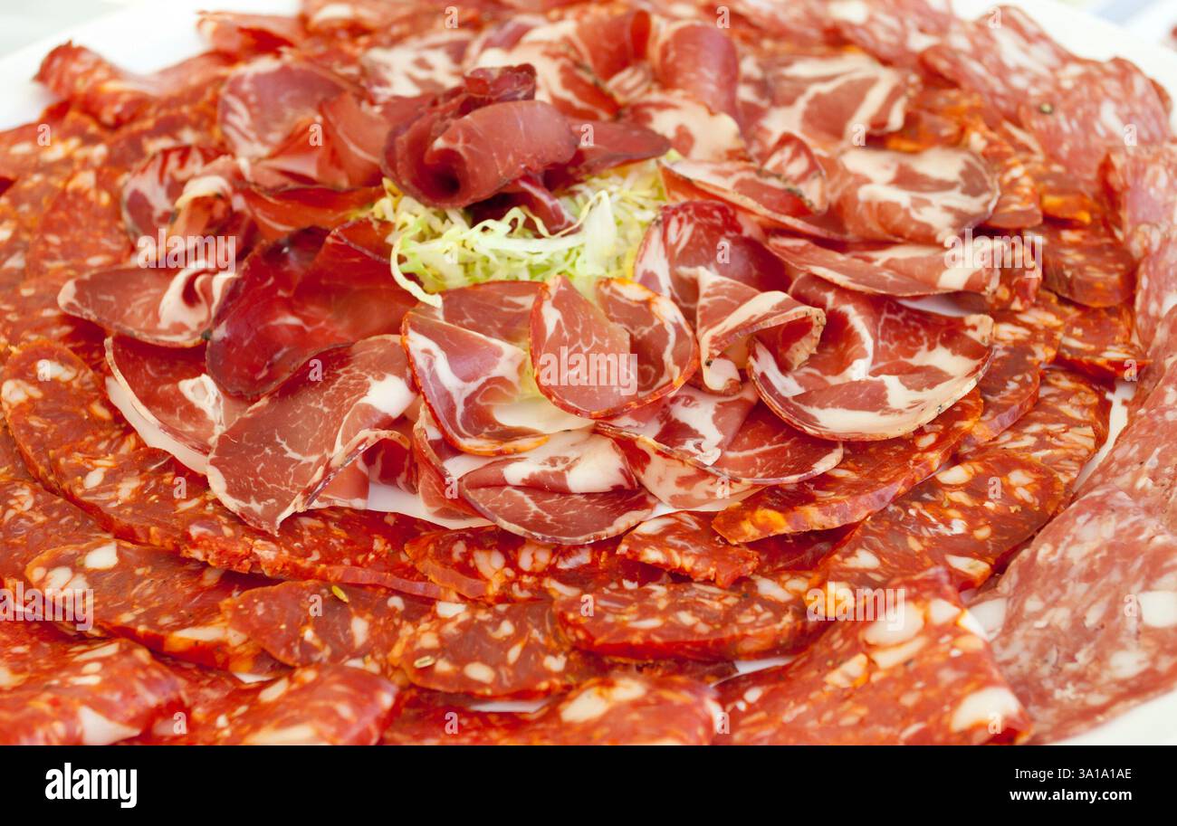 Plate of ham and spicy salami Stock Photo - Alamy