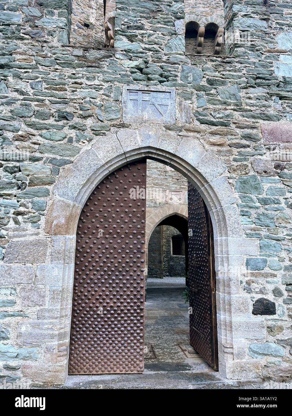 Studded wooden door of Fenis Castle in Aosta Valley, Italy, slightly ...