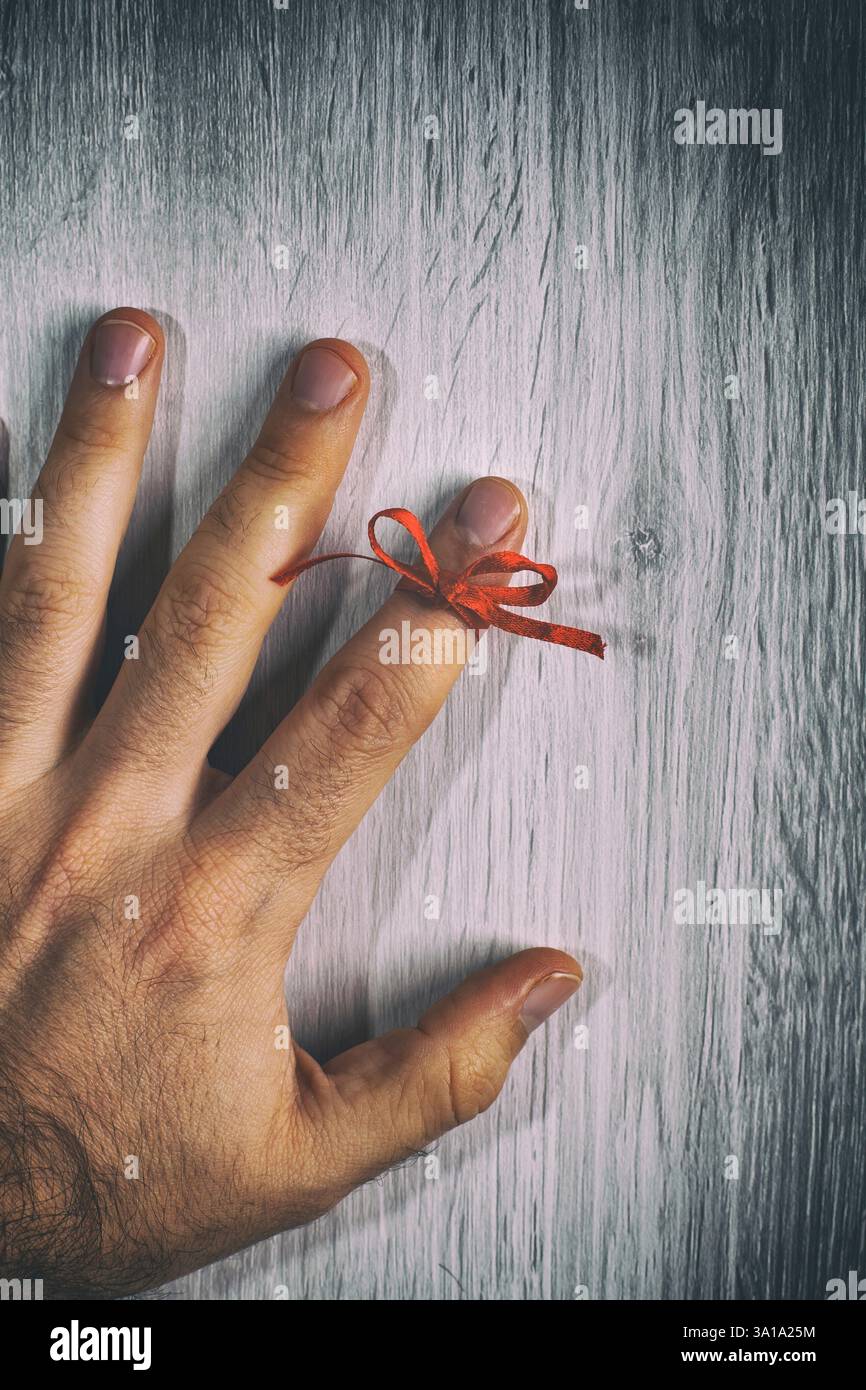 Red String Tied Around a Finger. Memory and Reminder Knot Stock Photo ...