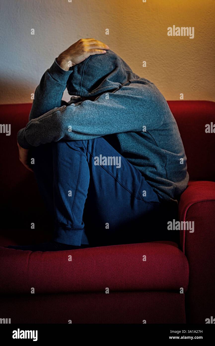 Curled up with his head in his hands hi-res stock photography and ...