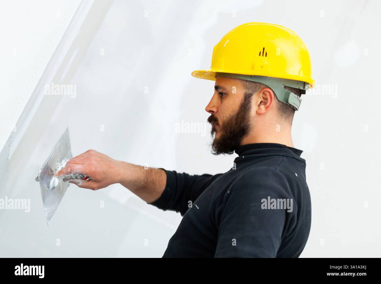 Interior construction, worker plastering gypsum board wall Stock Photo ...