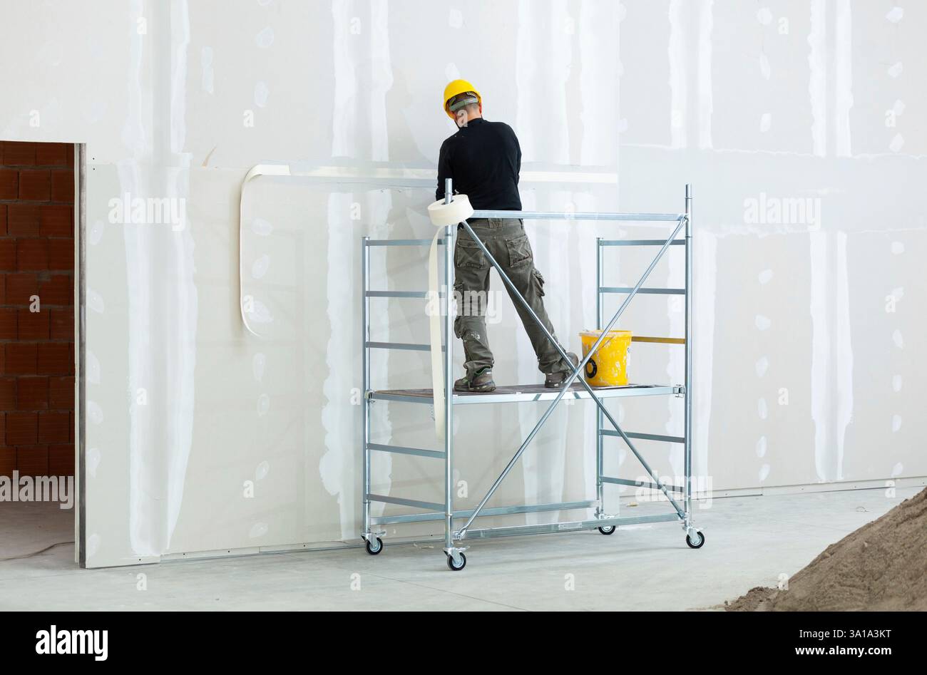 Interior construction, worker plastering gypsum board wall Stock Photo ...