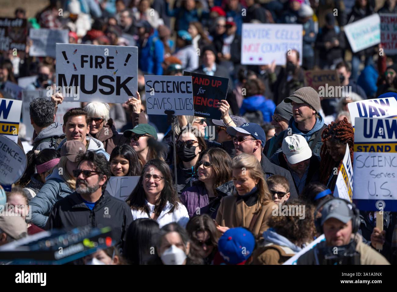 Demonstrators hold signs as they attend the Stand Up For Science rally ...