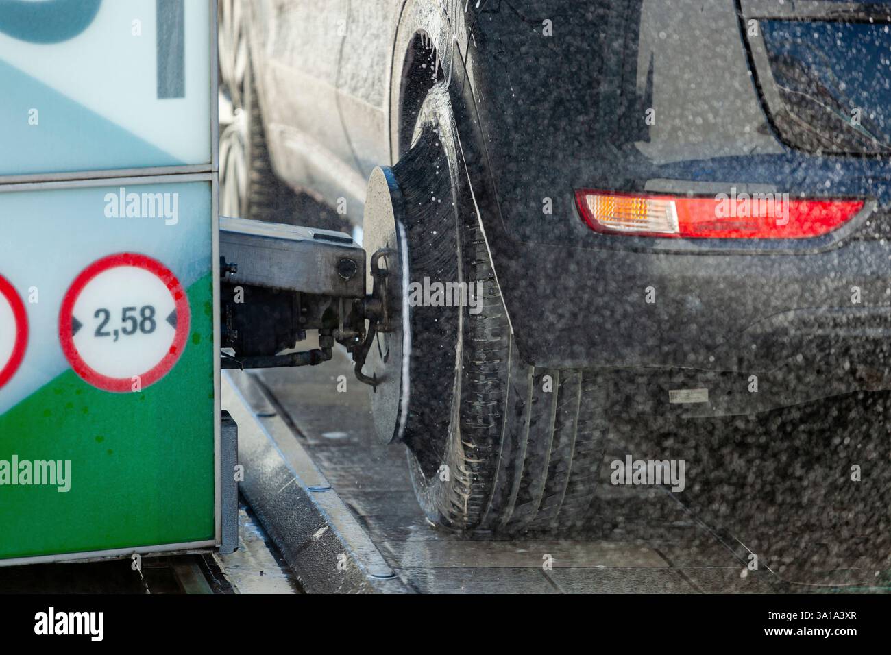 Contemporary car wash facility is washing a car in the winter season ...
