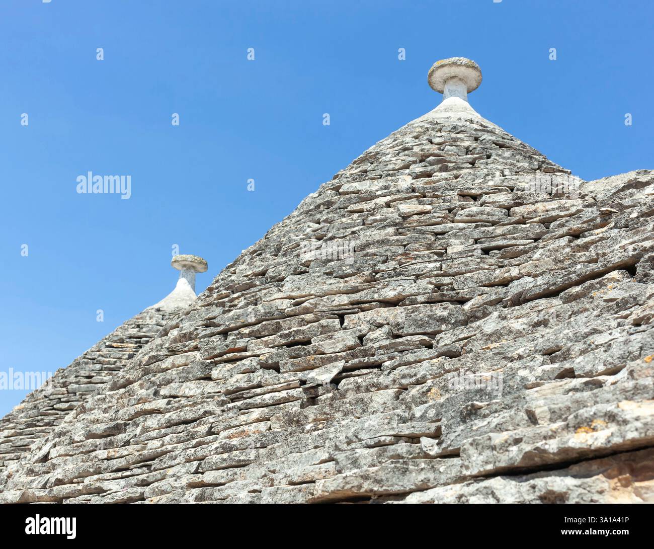 The trulli of alberobello are famous for their conical roofs made of ...