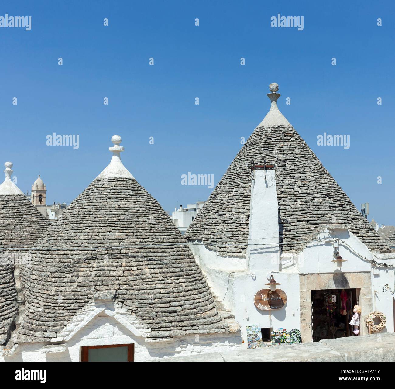 Traditional trulli houses with conical roofs made of stone, creating a ...
