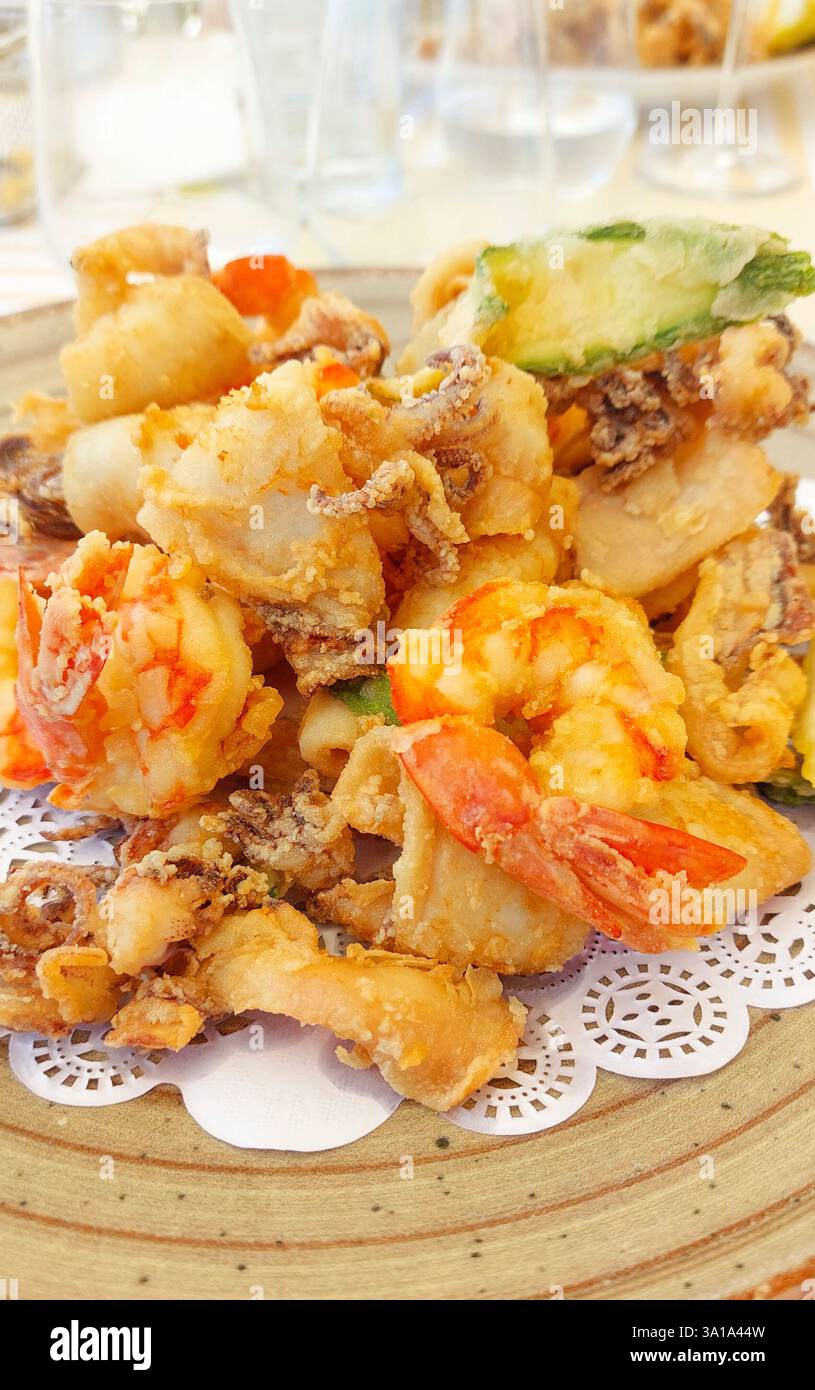 Delicious plate of fried fish with shrimps and zucchini, a typical dish ...