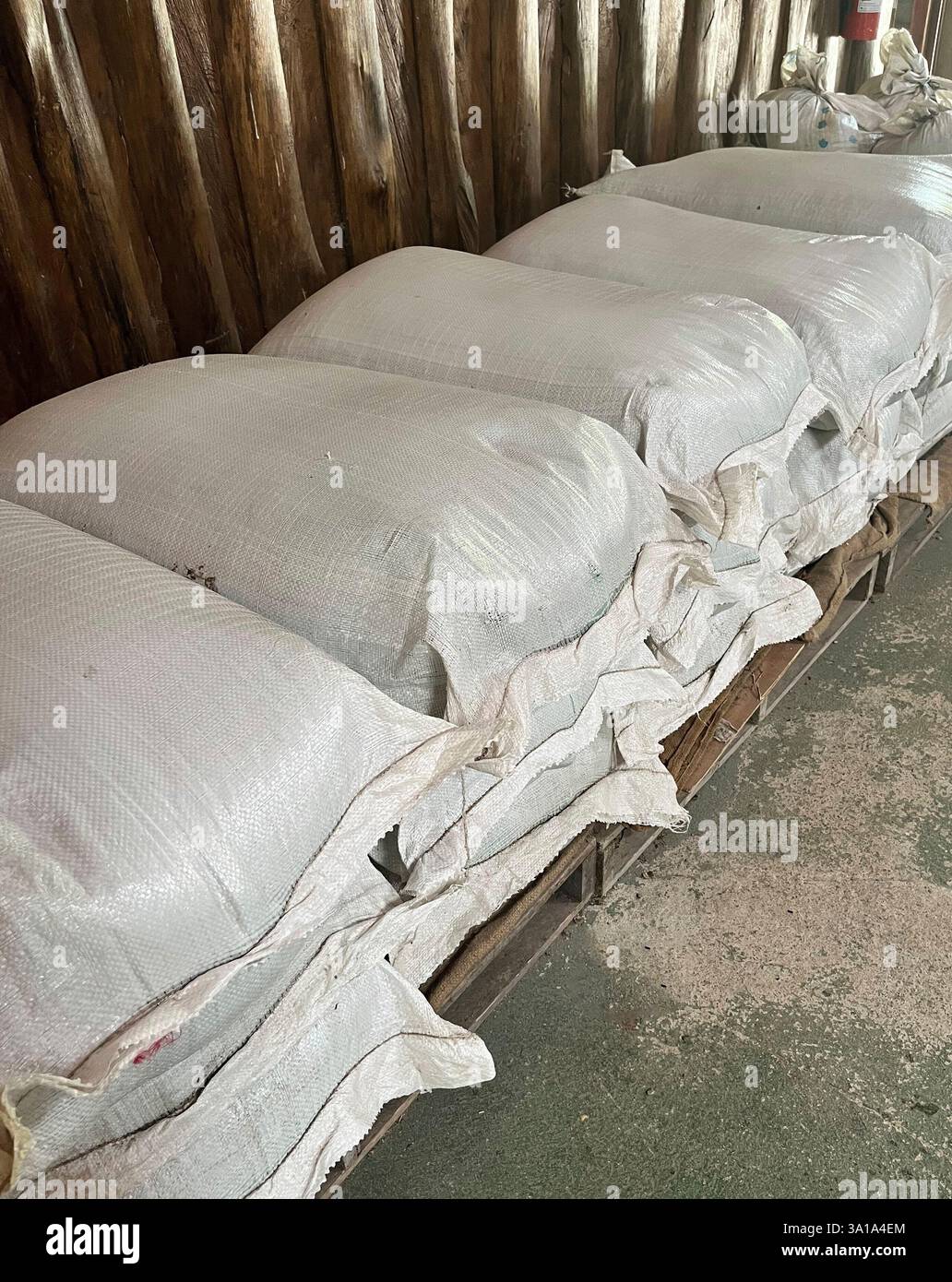 Stack of the white bags at warehouse Stock Photo - Alamy