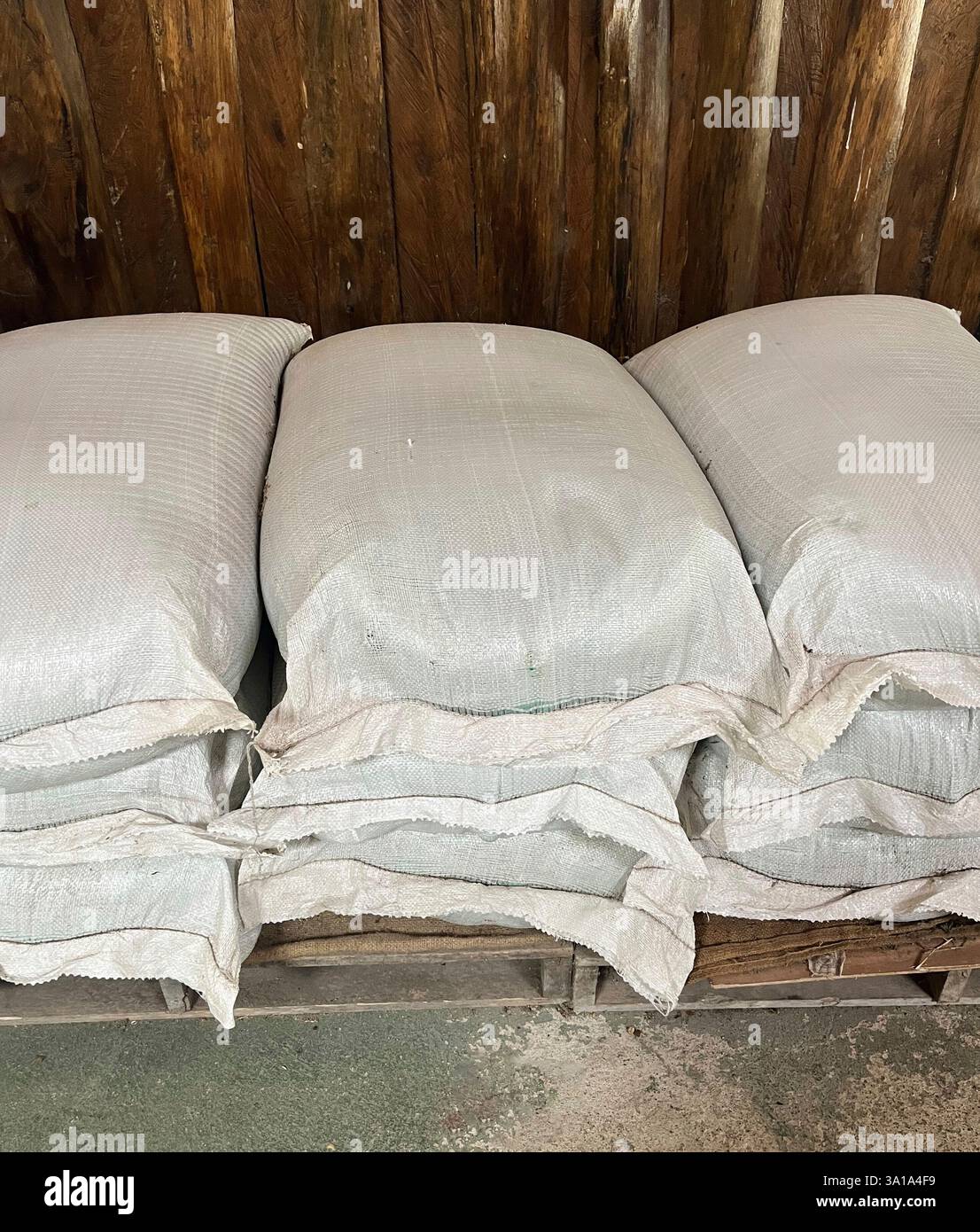 Stack of the white bags at warehouse Stock Photo - Alamy
