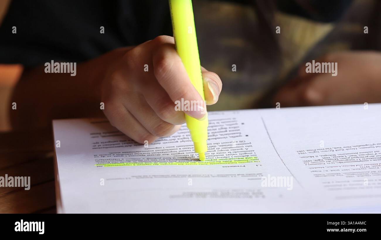 Female Student Highlighting A Page Stock Photo - Alamy