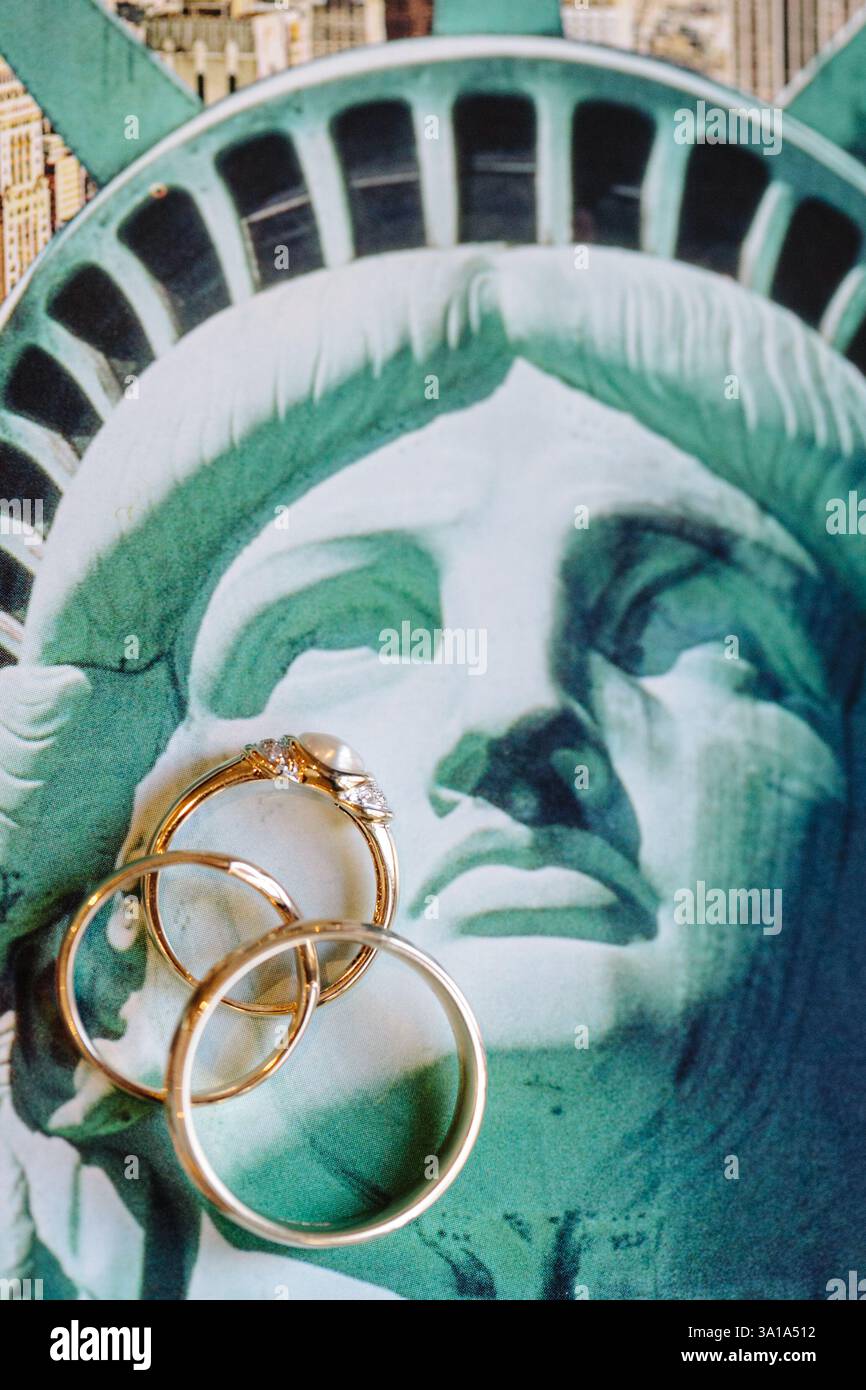 Gold rings artfully placed by the Statue of Liberty blend themes of ...