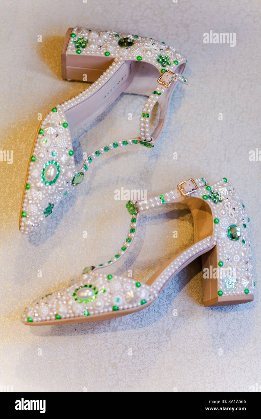 Detailed beaded shoes featuring green and white embellishments are ...