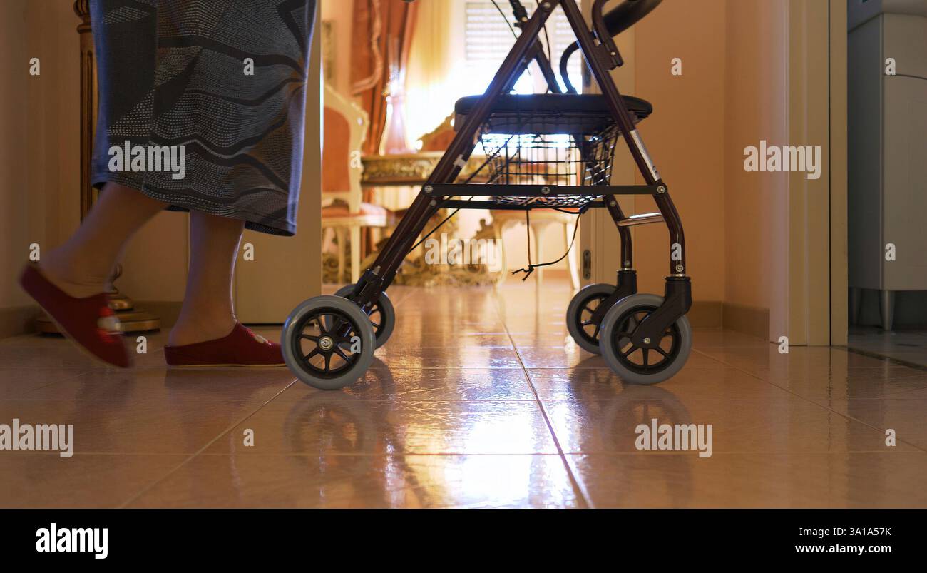 Elderly woman walks home walker hi-res stock photography and images - Alamy