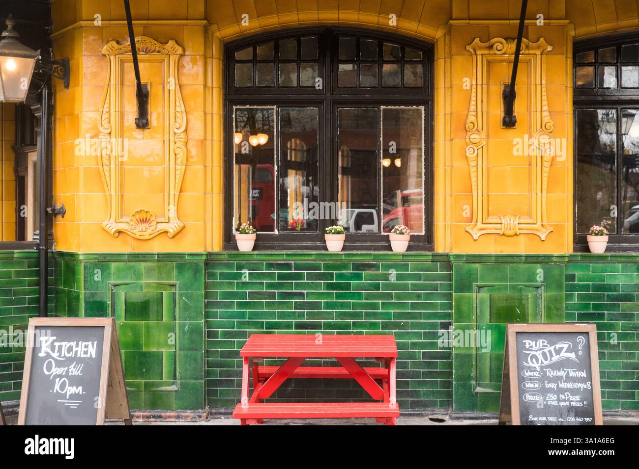 Railway Tavern pub, London, features yellow/orange and green tiled ...