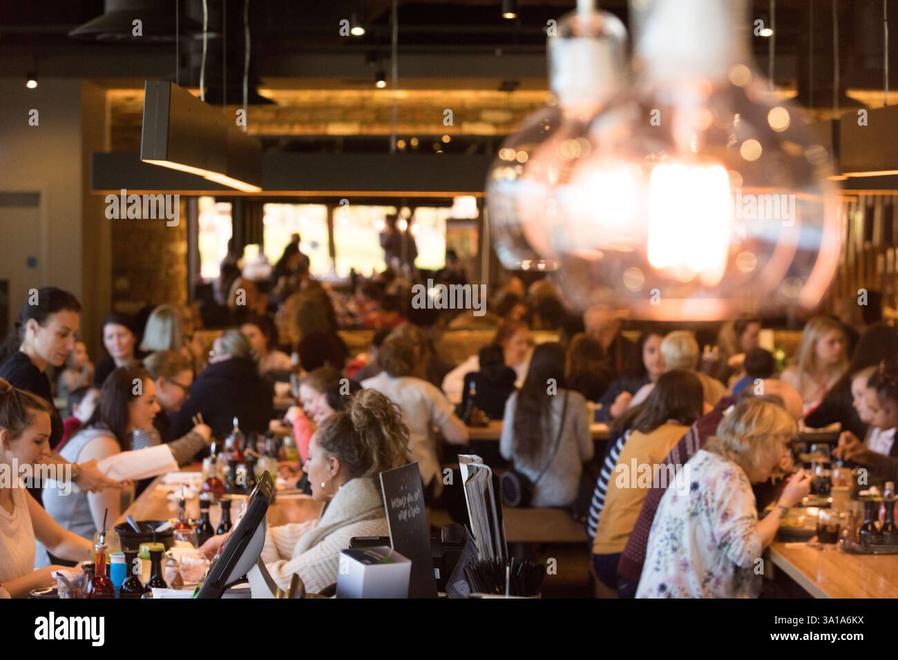 Customers dine at a busy restaurant Stock Photo - Alamy