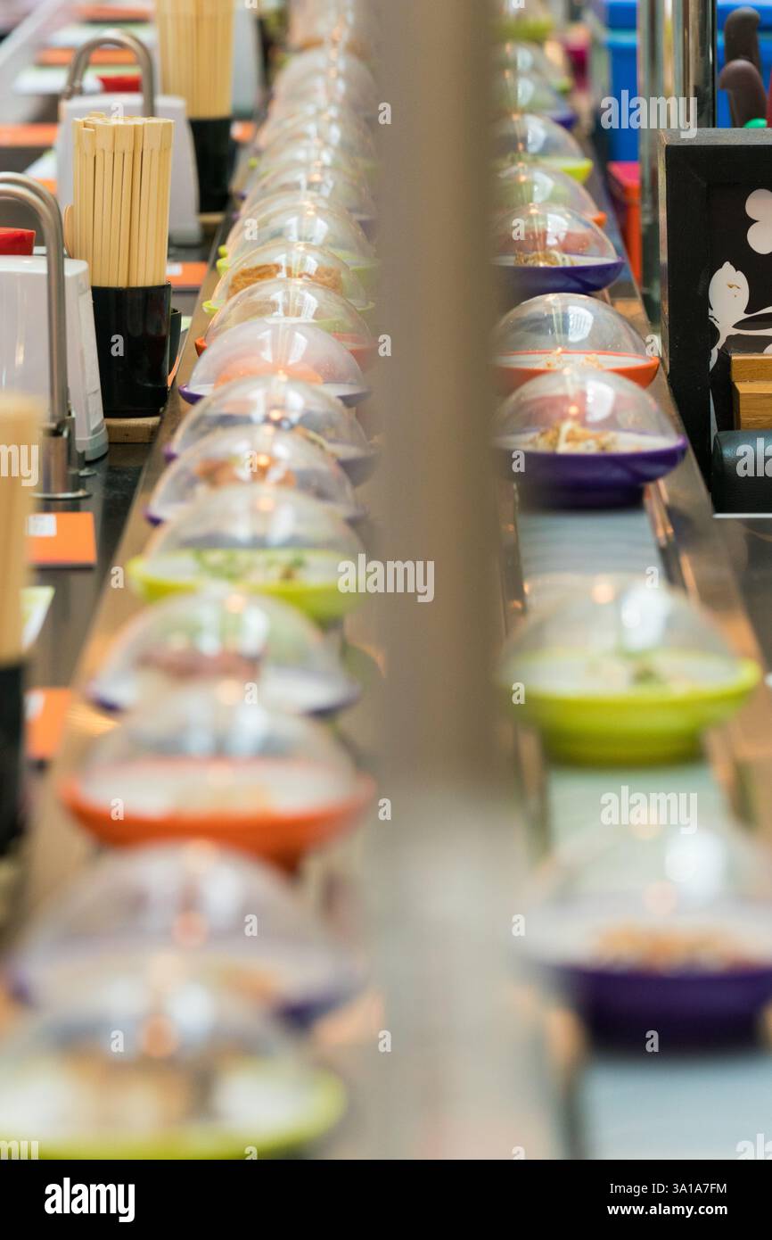 Sushi conveyor belt at a restaurant Stock Photo - Alamy