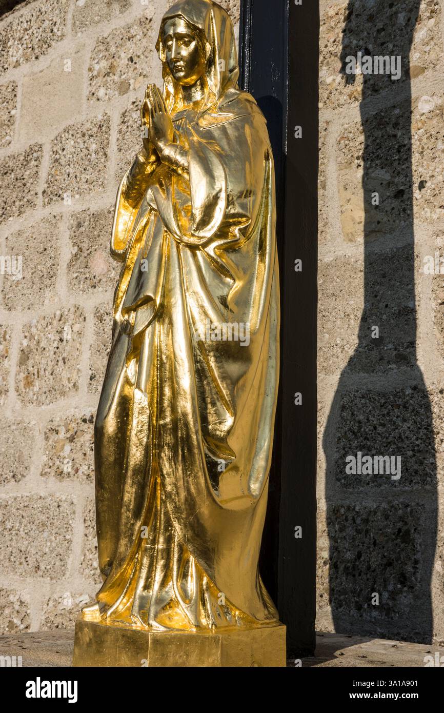 golden statue of the Virgin Mary in front of the Church of the Nativity ...