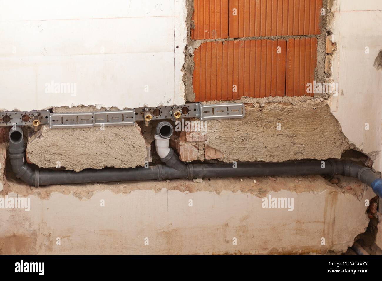 New installation of a drain pipe in an old building Stock Photo - Alamy