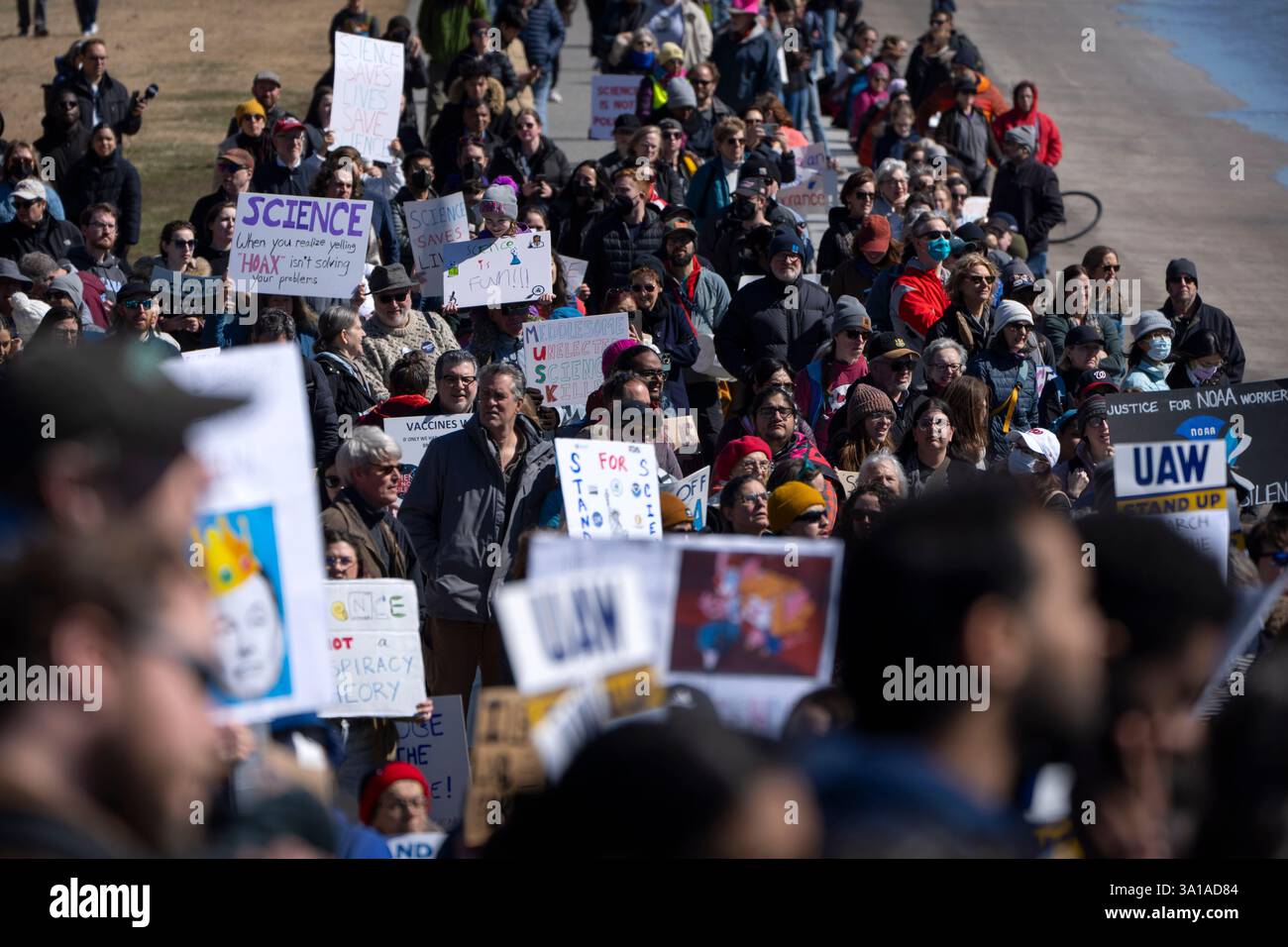 Demonstrators hold signs as they attend the Stand Up For Science rally ...