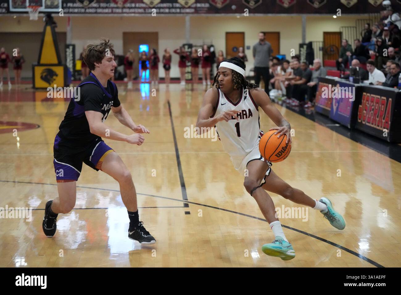 BJ Davis-Rey of JSerra (1) dribbles the ball against Jake Hall of Carlsbad (23) during a CIF ...
