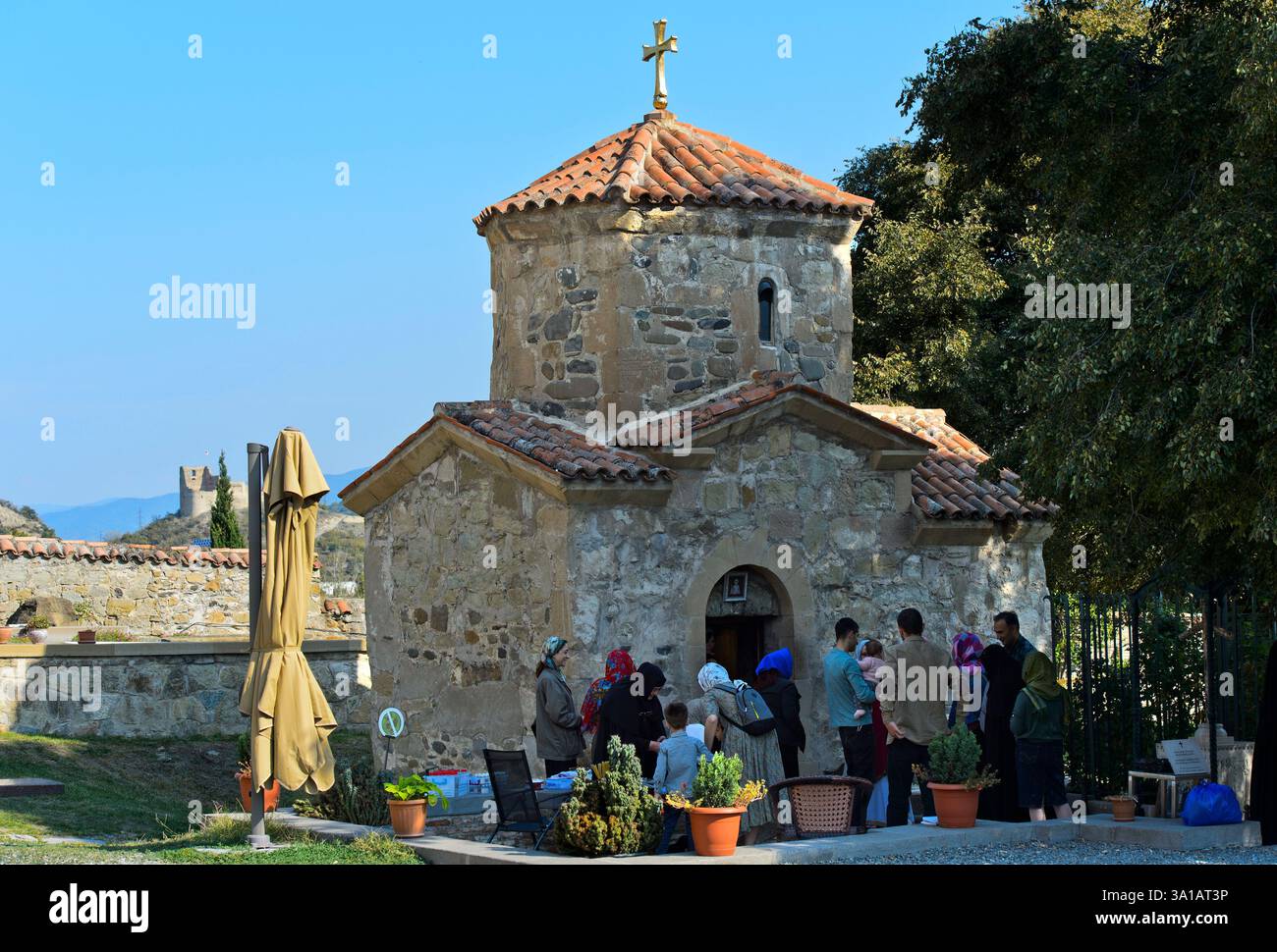 Pilgrims at the entrance to the Church of St. Nino, Samtavro Monastery ...