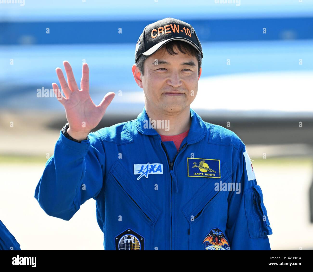 JAXA Astronaut Takoya Onishi waves to the media after arriving at the ...