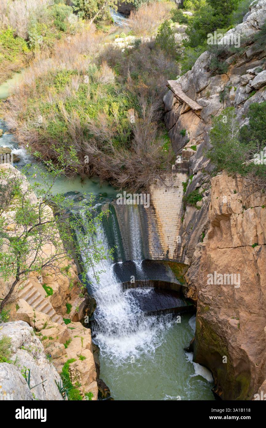A scenic view of flowing water cascading over rocky ledges into a river ...