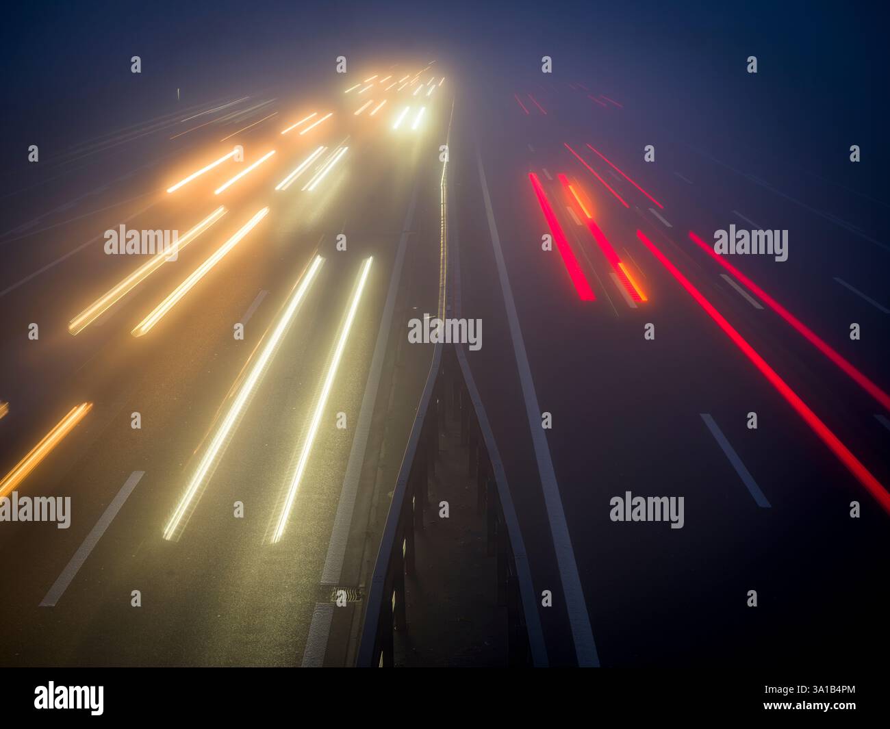 Light trails in the fog on the highway Stock Photo - Alamy