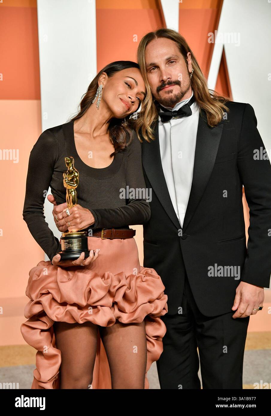 Zoe Saldana, left, and husband Marco Perego-Saldana arrive at the ...