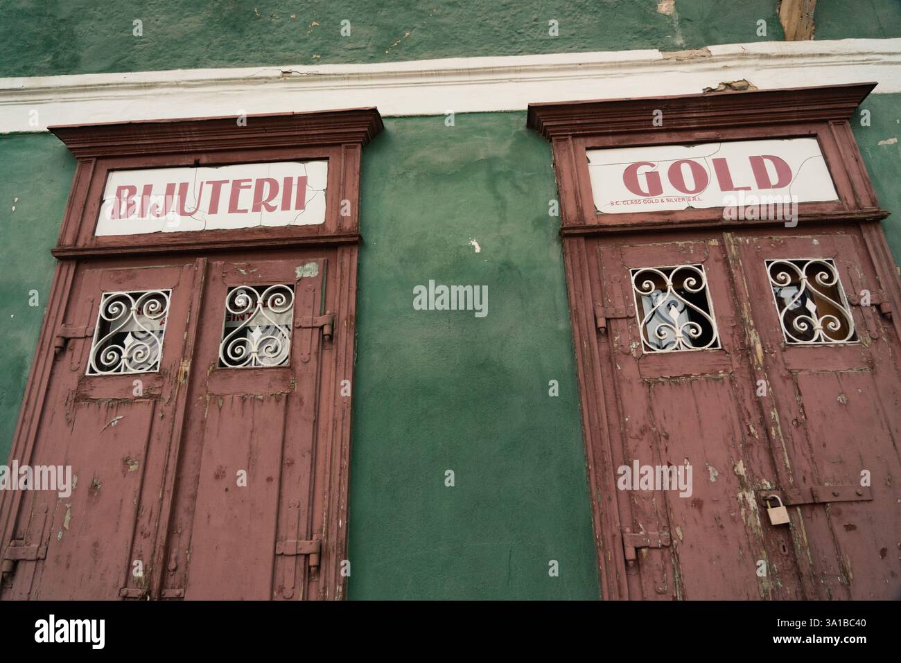 Old, weathered doors with "Bijuteri" and "Gold" signs, likely a jewelry ...