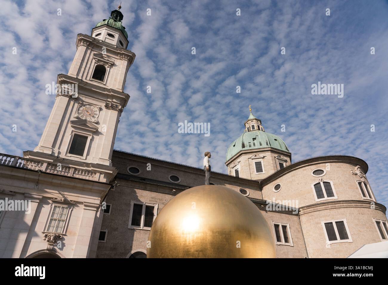Golden sphere sculpture, a boy figure atop, Salzburg Cathedral, Austria ...