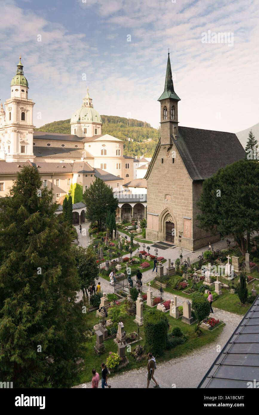 St. Peter's Abbey cemetery, Salzburg, Austria. Visitors stroll among ...